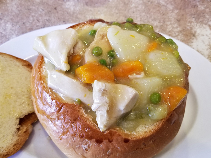 Behold the legendary chicken pot pie! This bread bowl masterpiece cradles tender chicken, vibrant vegetables, and velvety gravy in a carb-lover's dream come true.