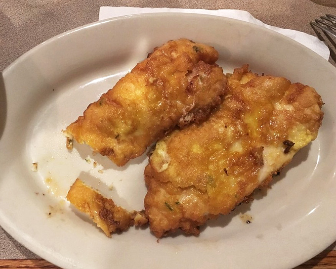 Behold the star attraction: Chicken Romano in all its golden glory. That cheese crust shatters like delicate glass, revealing juicy chicken beneath&mdash;a textural masterpiece.