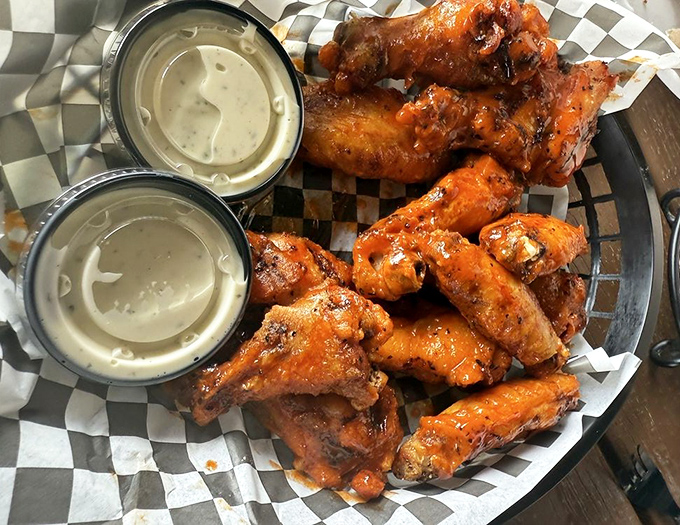 These wings aren't just served; they're presented like the culinary celebrities they are, glistening with sauce and flanked by cooling ranch.