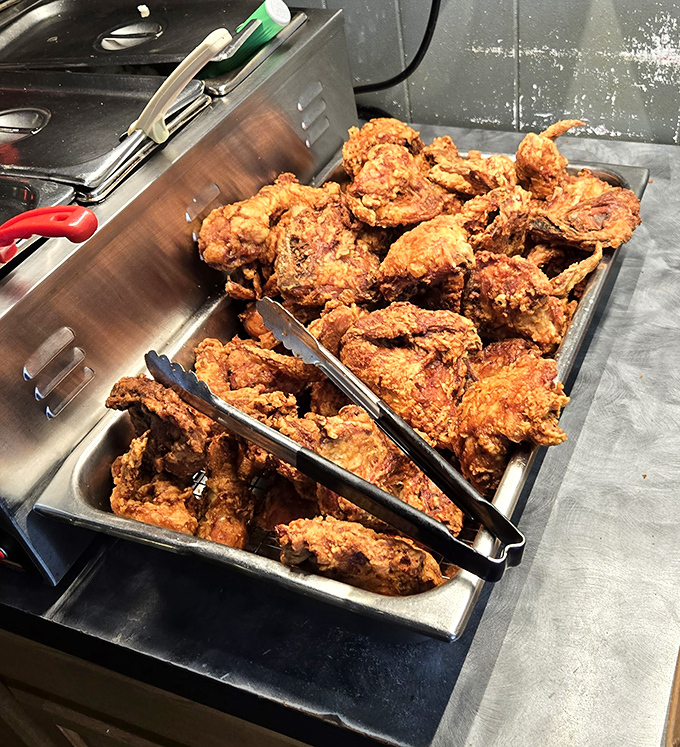 Golden-brown perfection awaits in this tray of freshly fried chicken, each piece promising a symphony of crunch and juicy tenderness.