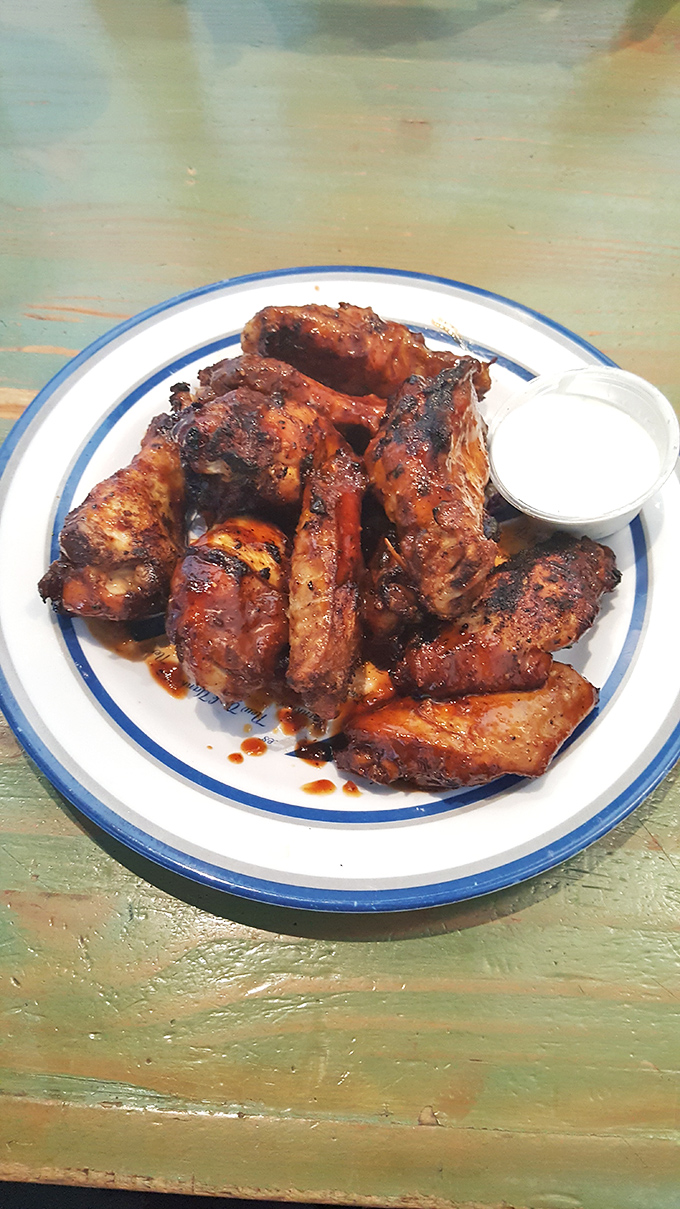 These aren't just wings &ndash; they're smoke-kissed masterpieces that make other chicken parts jealous. The blue-rimmed plate is practically a victory lap.