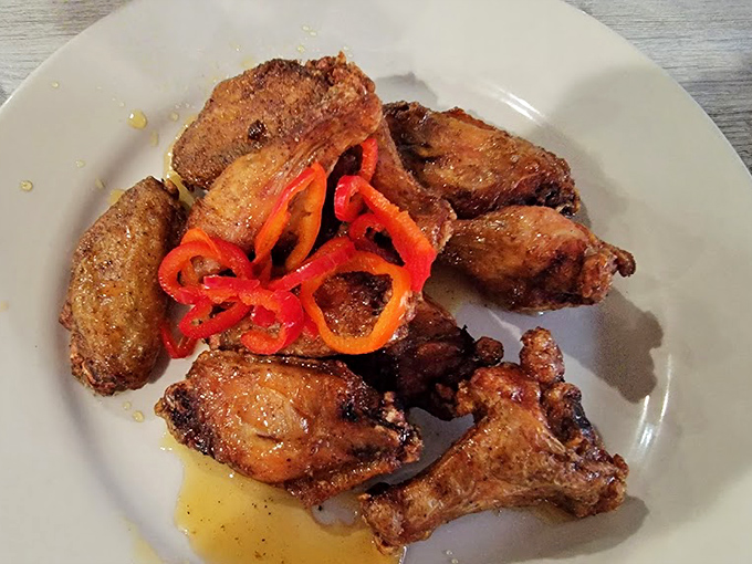 These aren't just wings; they're crispy-skinned flavor bombs topped with vibrant peppers that'll make your taste buds stand at attention.