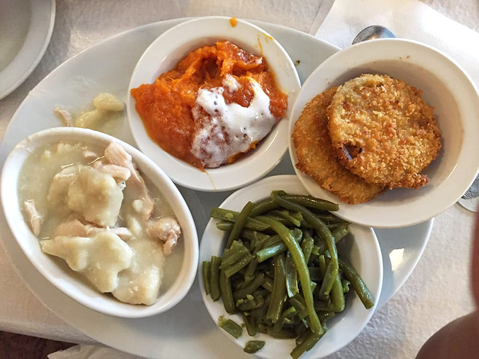 Behold the star attraction: chicken and dumplings that would make your grandmother both jealous and proud, swimming in broth that's practically liquid gold.