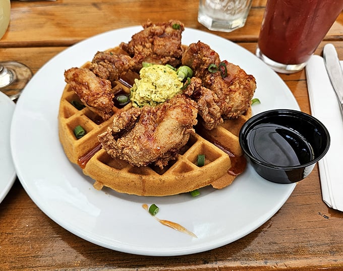 The holy grail of comfort food: crispy fried chicken perched atop a golden waffle, with maple syrup standing by to create that perfect sweet-savory marriage.