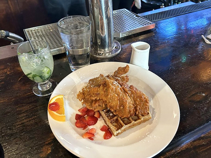 The holy grail of comfort food! Golden-fried chicken perched atop a fluffy waffle with fresh berries &ndash; a breakfast-dinner mashup worthy of worship.