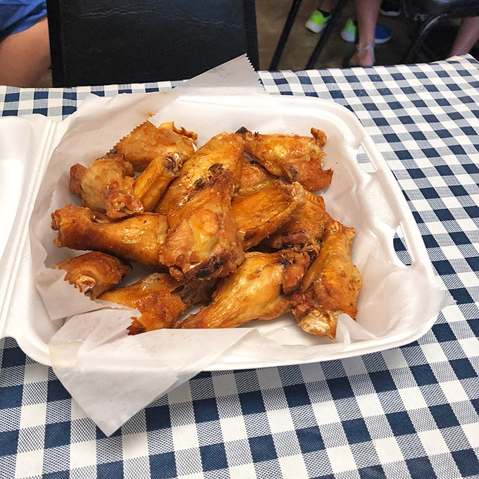 Golden-brown chicken wings that don't need fancy plating to make their point. The kind of wings that render conversation impossible except for appreciative mumbling.