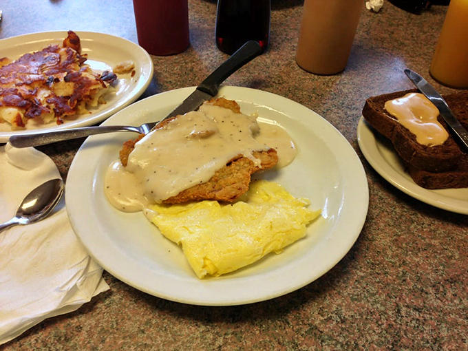 Behold the star attraction! Golden-crisp chicken fried steak smothered in peppery gravy alongside fluffy eggs&mdash;a plate that makes diets weep and souls rejoice.