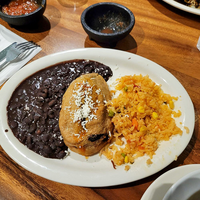 The star of the show: a chile relleno that's achieved the impossible balance of crispy exterior and molten interior, flanked by black beans that aren't afterthoughts.