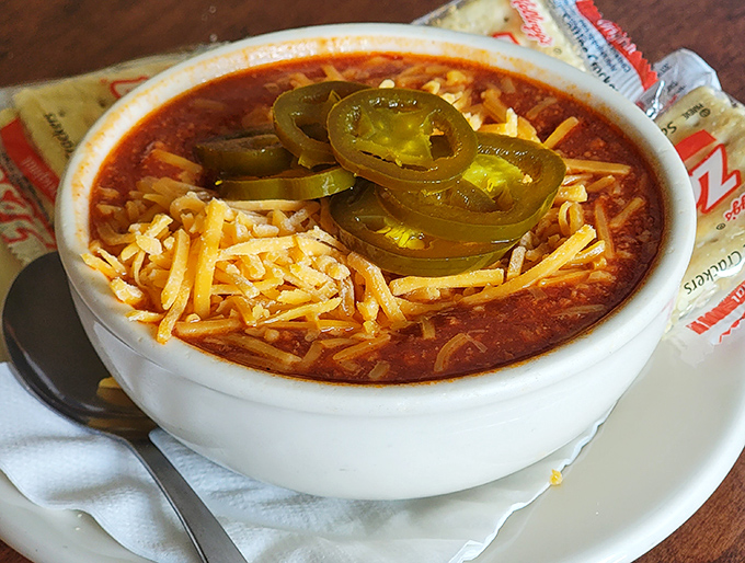 Zip's Famous Chili arrives crowned with melted cheddar and jalape&ntilde;os &ndash; a spicy halo that transforms an everyday bowl into something worth crossing town for.