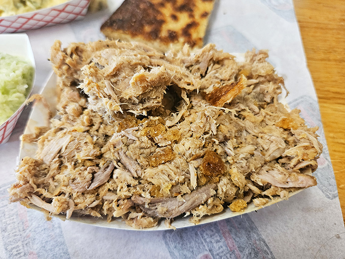 This isn't just chopped pork—it's a masterpiece of smoke, meat, and cracklins all mingling together in perfect harmony. The Holy Grail of Eastern Carolina BBQ.