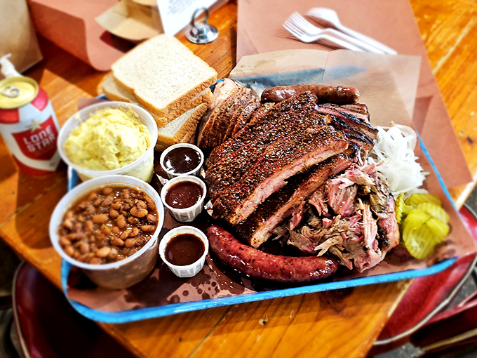 Behold the holy trinity of Texas BBQ: brisket with that perfect bark, sausage with the snap, and sides that know their supporting role.