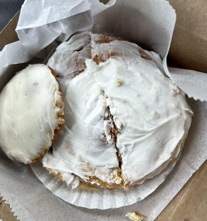 Behold the star of the show: a cinnamon roll so generously frosted it could qualify for its own zip code.