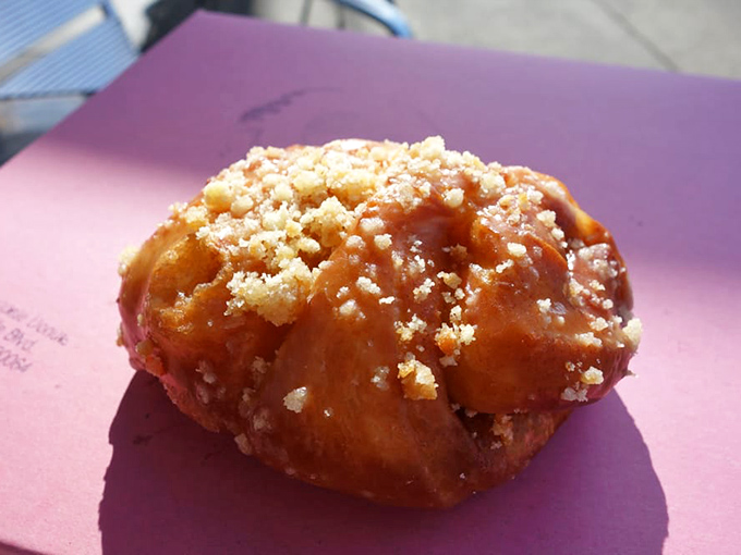 This isn't just a donut—it's edible architecture. The golden-fried cinnamon creation with its crumbly topping practically begs for a coffee companion.