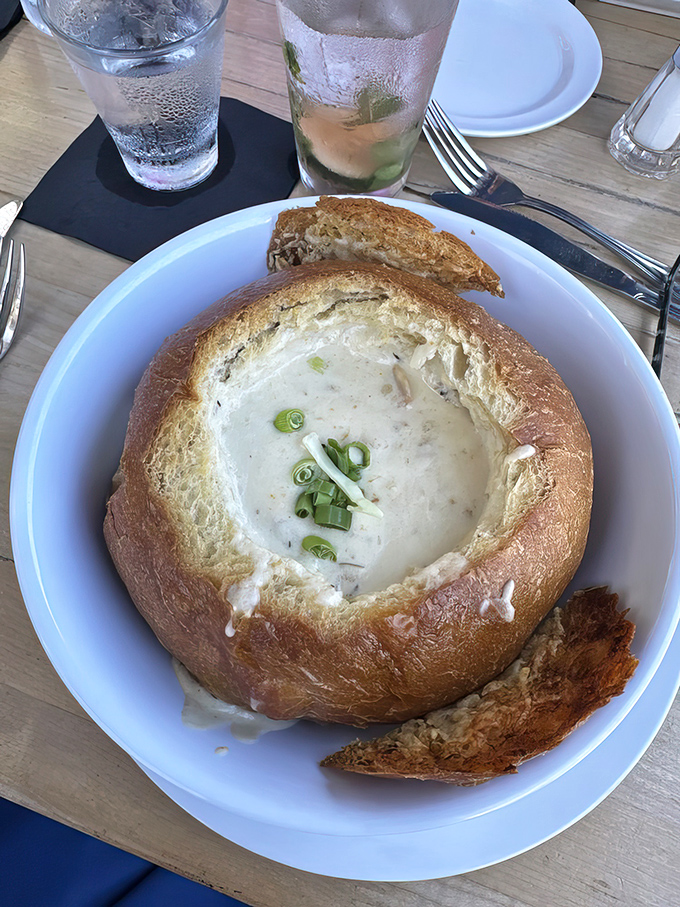 Not just any clam chowder &ndash; this sourdough bread bowl cradles creamy perfection topped with green onions, like a warm hug from the sea itself.