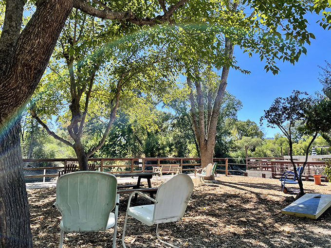 Shaded seating under ancient oaks &ndash; nature's air conditioning with a side of serenity. The perfect spot for afternoon conversations.