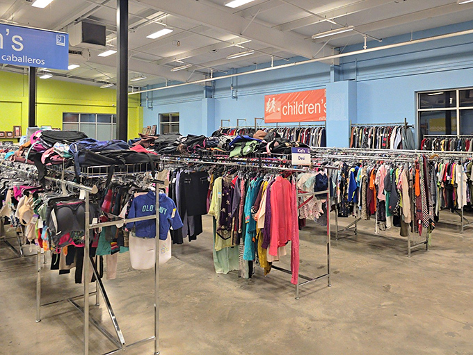 The children's section: where tiny fashionistas get started early. That blue wall isn't just a backdrop; it's the sky's-the-limit philosophy of thrift shopping made visible.