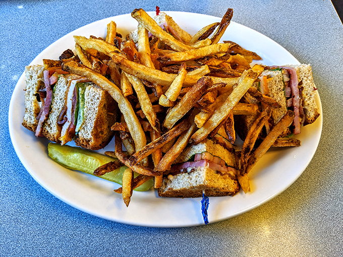 Not just a sandwich, but a towering achievement in lunch architecture&mdash;crispy fries, perfectly toasted bread, and that pickle spear standing guard.