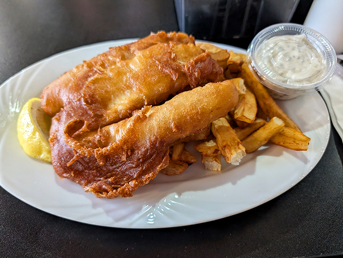 Golden-battered cod that shatters like glass when your fork hits it, revealing pearly white fish beneath. Vegas has its jackpots, but this plate is the real winner.