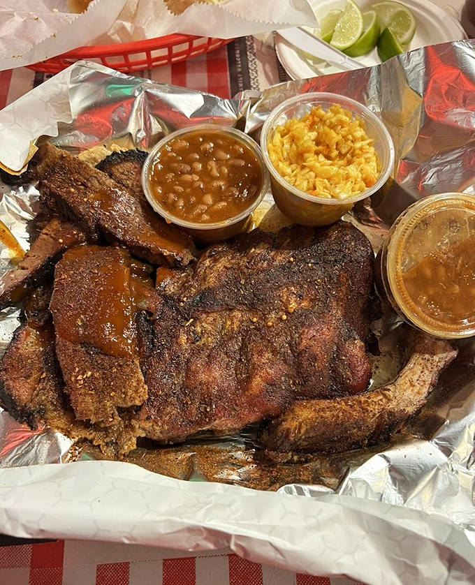 Barbecue artistry on full display&mdash;charcoal-kissed ribs with that signature reddish spice crust, flanked by beans and rice that know their supporting role.