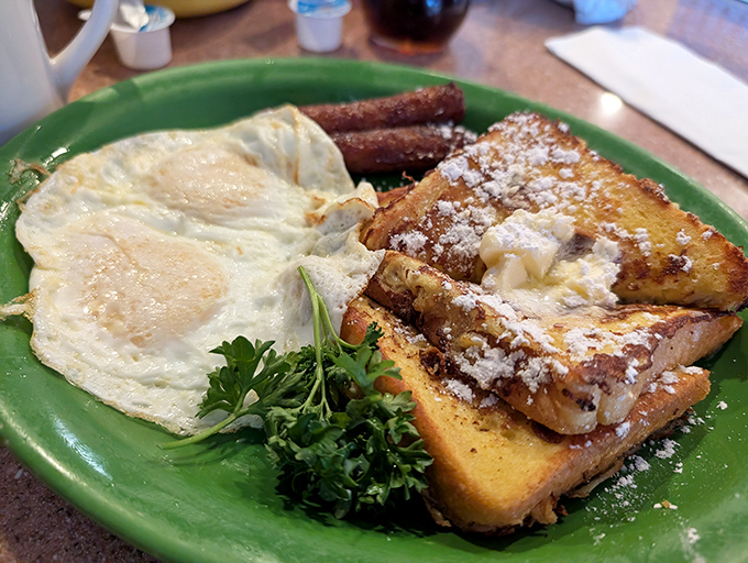 The legendary French toast combo in all its glory. That dusting of powdered sugar isn't decoration&mdash;it's a snowfall of happiness on your breakfast plate.