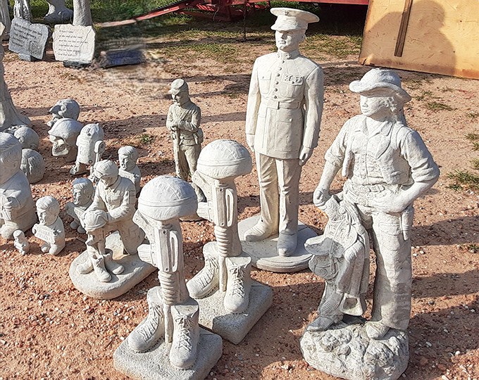These stoic concrete soldiers stand at attention, ready to guard your garden or patio with a touch of patriotic charm.