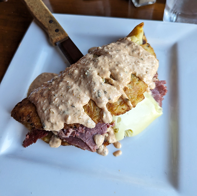 This isn't just a sandwich&mdash;it's architecture. Layers of corned beef and potatoes under a blanket of sauce that demands to be savored.