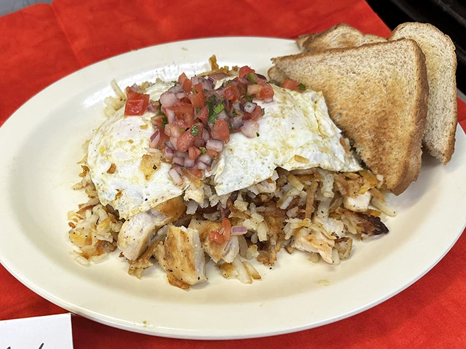 Breakfast architecture at its finest&mdash;eggs perched atop a foundation of crispy hash browns with pico de gallo adding a splash of color and flavor.