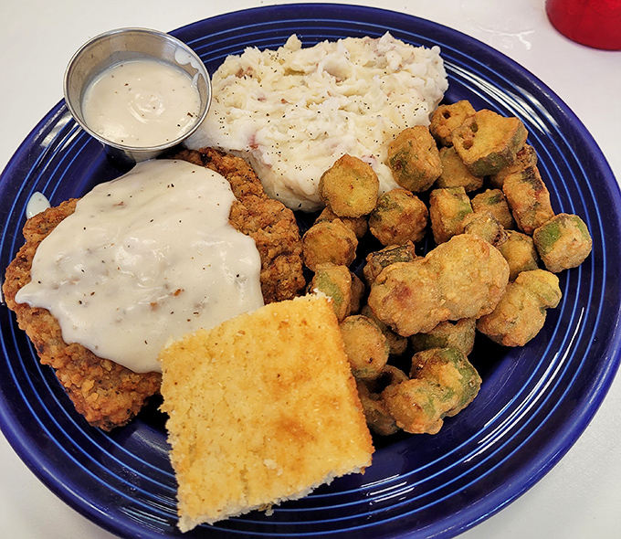 Country fried steak nirvana: golden-crisp exterior, tender interior, and gravy that would make your grandmother question her recipe.