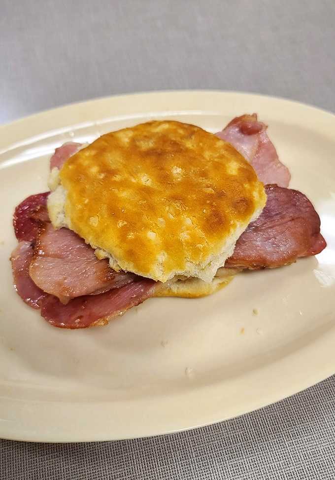Behold the star attraction: a golden-topped biscuit embracing thin-sliced country ham&mdash;poetry on a plate that speaks fluent Southern.