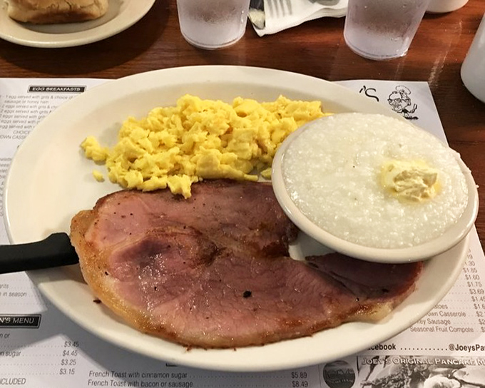 Country ham that doesn't mess around, paired with eggs that know their purpose in life. Grits standing by like a loyal sidekick.