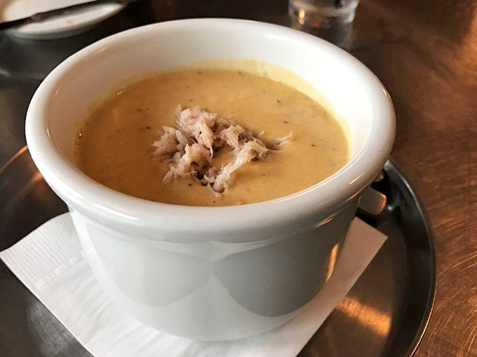 The crab bisque arrives like a warm hug in a bowl. That generous portion of lump crab meat isn't garnish&mdash;it's the treasure beneath the creamy waves.