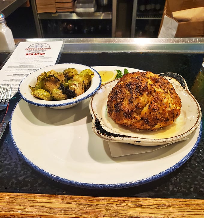 Behold the legendary Crab Bomb in all its golden-domed glory. This isn't just a crab cake; it's what other crab cakes dream of becoming when they grow up.