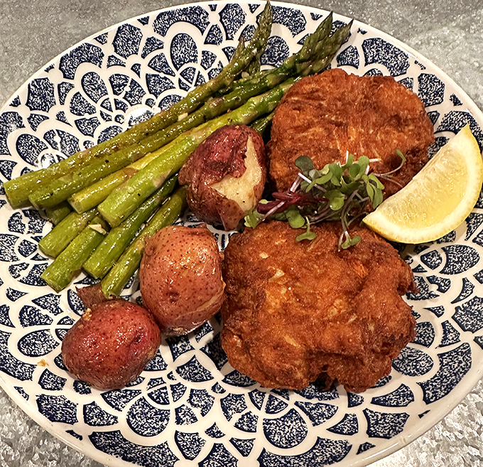Golden-fried perfection meets fresh asparagus in this plate symphony. The crab cakes at JP's don't hide behind fillers&mdash;they proudly showcase Delaware's briny bounty.