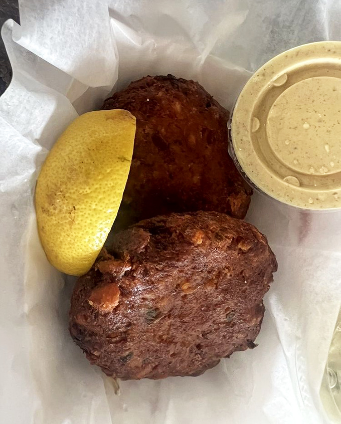 Two golden crab cakes that could make a Maryland native weep with jealousy and reconsider their life choices.
