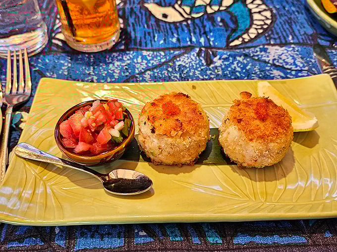 Crab cake nirvana! These golden-brown beauties aren't just appetizers &ndash; they're edible postcards from heaven, complete with tropical salsa that sings aloha to your taste buds.