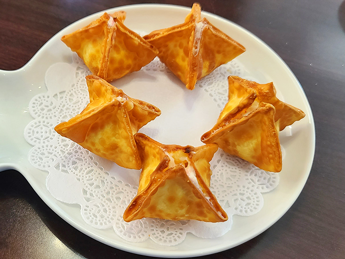 Crab Rangoon perfection: golden, crispy triangles filled with actual crab meat. Not playing hide-and-seek with the seafood here!