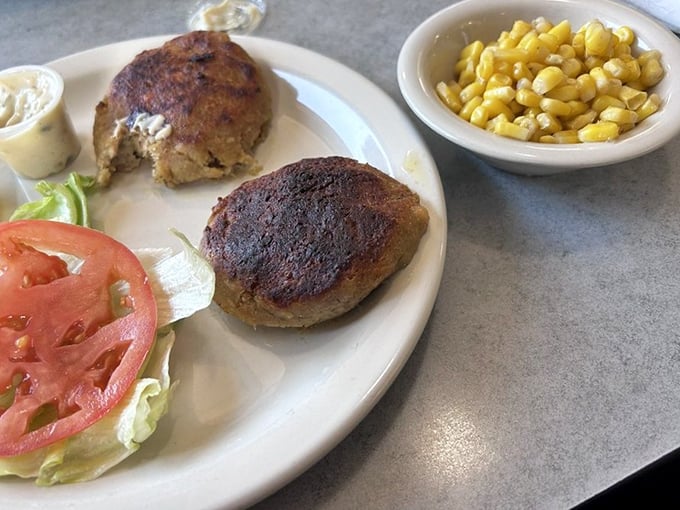 Behold the stars of the show&mdash;crab cakes with minimal filler and maximum flavor, perfectly browned and served with corn that's sweeter than a love letter.