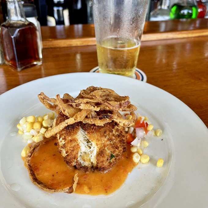 This crab cake isn't just a dish&mdash;it's an event, crowned with crispy wisps and surrounded by a moat of sauce you'll want to swim in.
