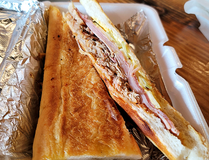 The Cuban sandwich, reimagined&mdash;where pressed perfection meets smoky pulled pork in a handheld miracle that screams "Tampa" with every bite.