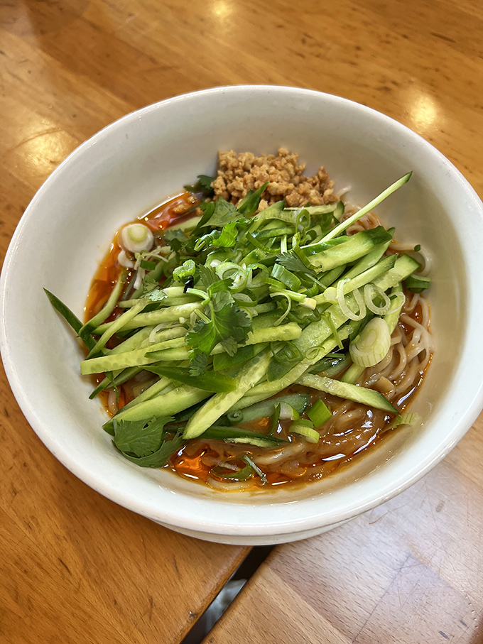 Behold: the dan dan noodles that launched a thousand road trips. Fresh cucumber, vibrant herbs, and that sauce—oh, that sauce—creating a bowl of noodle nirvana worth crossing state lines for.