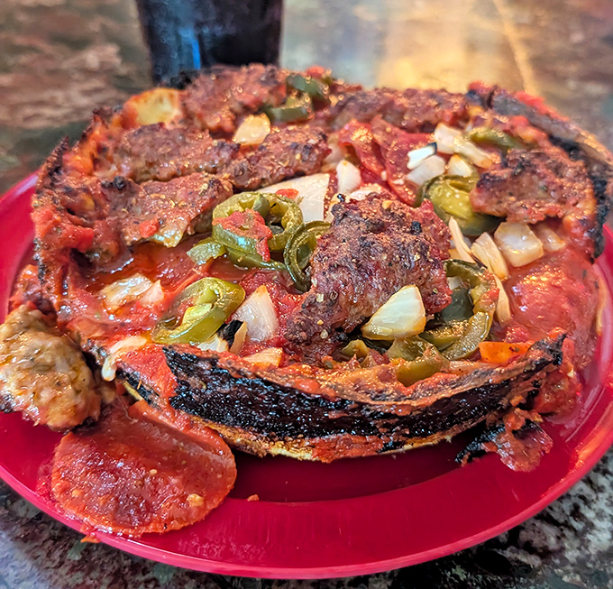 Behold the holy grail of deep dish&mdash;that blackened caramelized edge isn't burnt, it's flavor architecture. Green peppers and sausage play supporting roles.