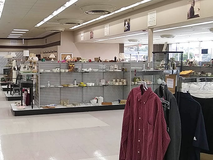 Organized clothing racks stretch as far as the eye can see, with helpful signs indicating which charitable programs your purchases support.