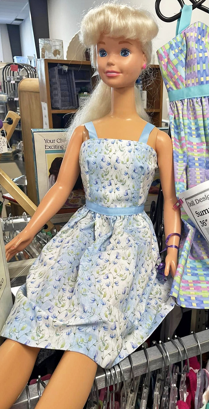 This vintage doll in her handmade floral dress waits patiently for a new home. Someone's childhood treasure becomes another's delightful discovery.