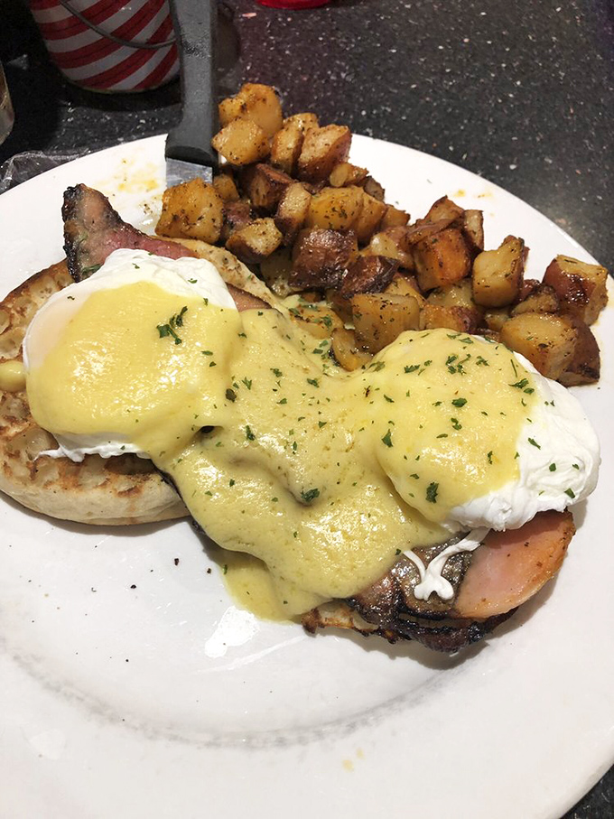 Behold, the star of our show! This Eggs Benedict features perfectly poached eggs with hollandaise cascading down like a yellow waterfall of happiness.