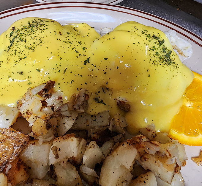 Behold the star attraction &ndash; hollandaise cascading over perfectly poached eggs like a sunrise over the Delaware countryside. Poetry on a plate.