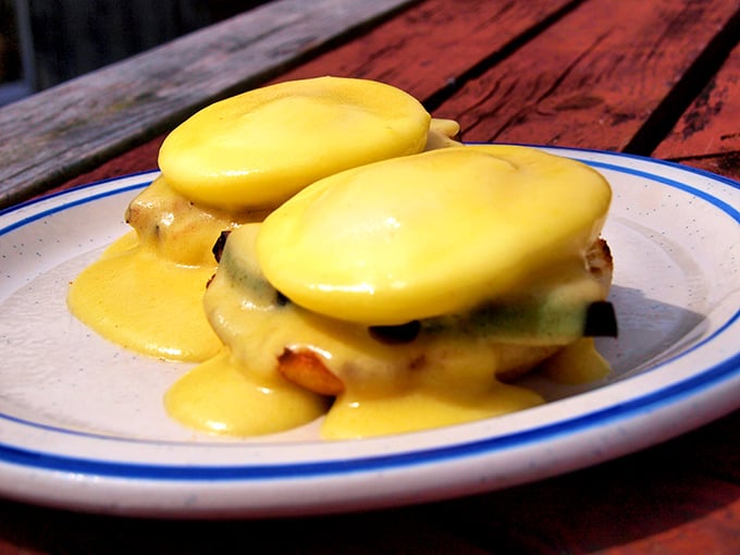 Eggs Benedict reimagined with hollandaise so golden it deserves its own Fort Knox. Breakfast architecture at its finest.