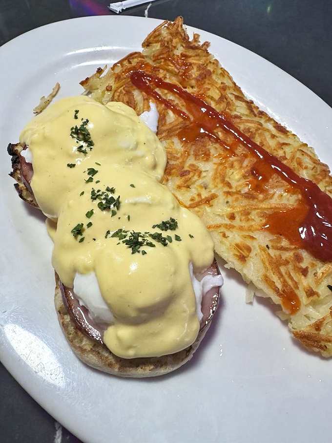 Behold Nevada's finest eggs benedict, where golden hollandaise flows like liquid sunshine over perfectly poached eggs and crispy hash browns.