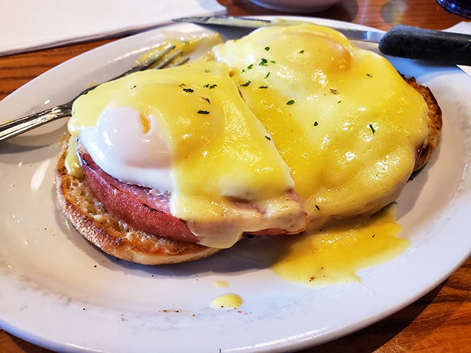 Behold, the star of our show! Golden hollandaise cascades over perfectly poached eggs and Canadian bacon&mdash;a breakfast masterpiece worthy of its own monument.