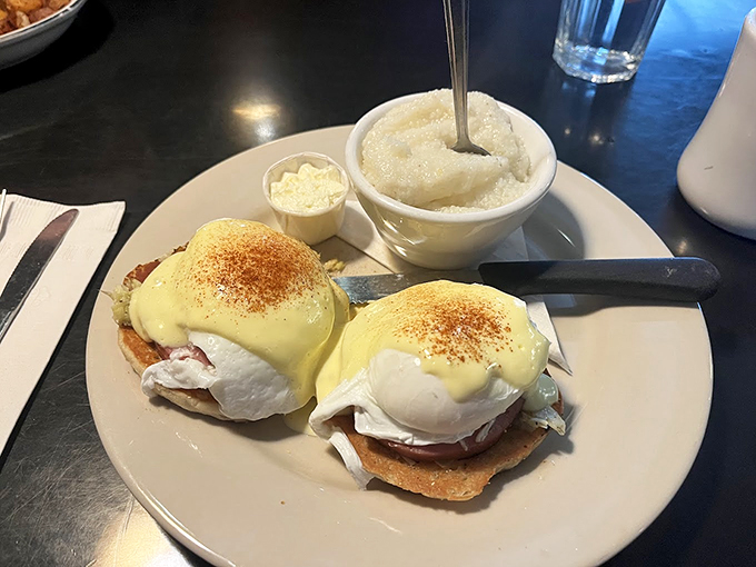 Behold, the star of the show! Two perfectly poached eggs nestled on English muffins, draped in hollandaise that practically winks at you. Side of grits? Yes, please.