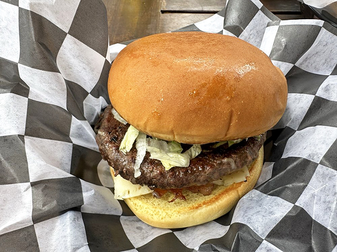 Behold the burger in its natural habitat &ndash; perfectly charred, nestled on a toasted bun. This isn't fast food; it's food worth slowing down for.
